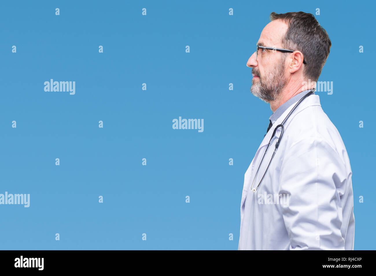 Middle age senior hoary doctor man wearing medical uniform isolated ...