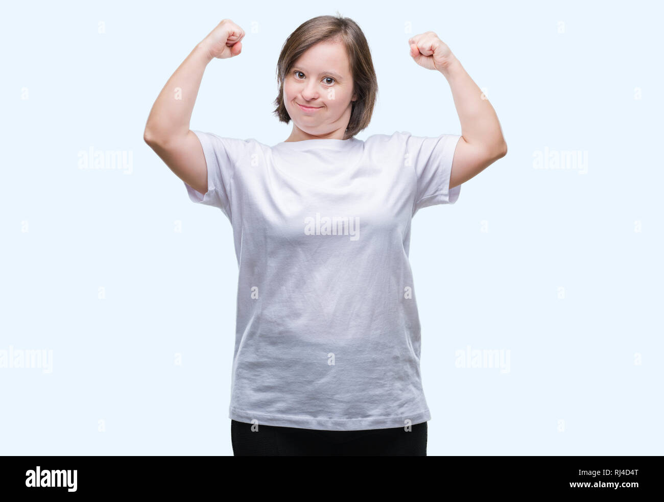 Young adult woman with down syndrome over isolated background showing ...