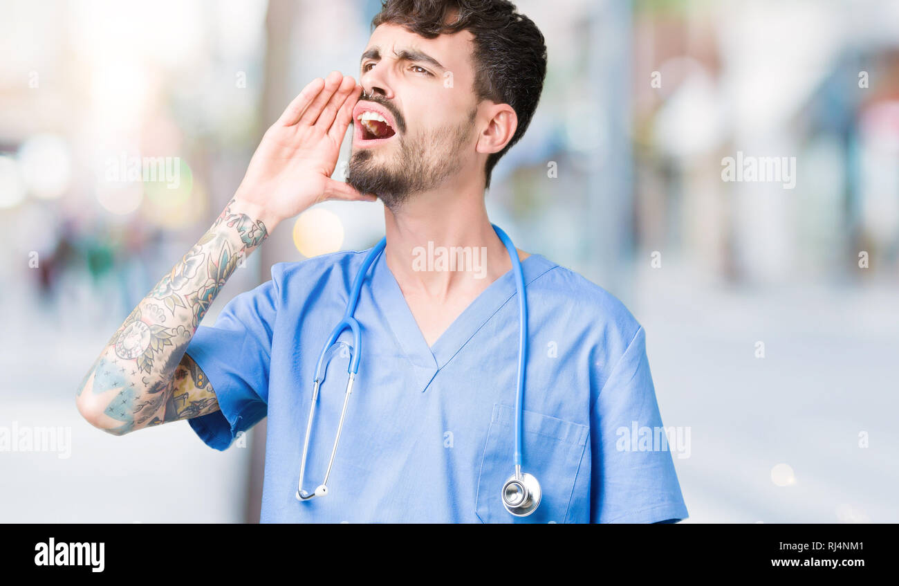 Young handsome nurse man wearing surgeon uniform over isolated ...