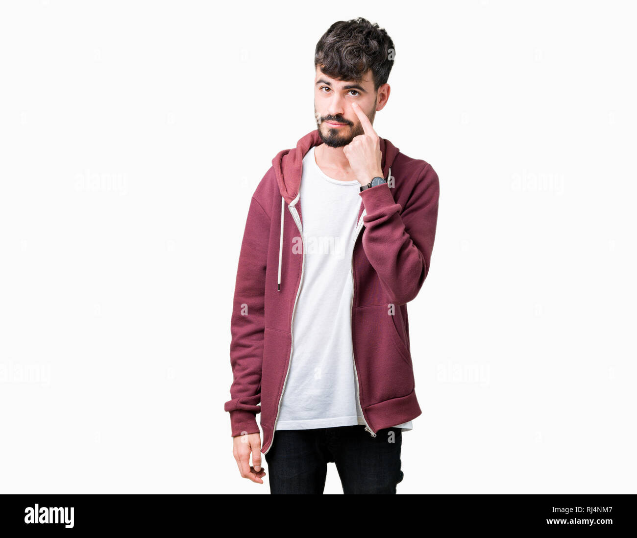 Young handsome man over isolated background Pointing to the eye ...