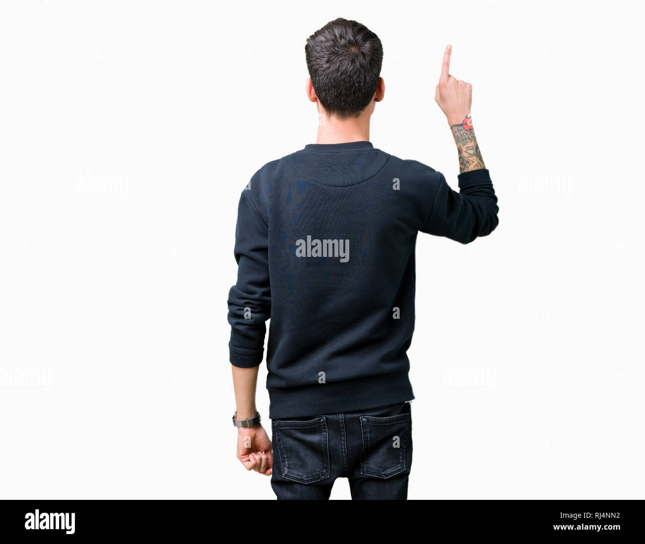 Young handsome man over isolated background Posing backwards pointing ...