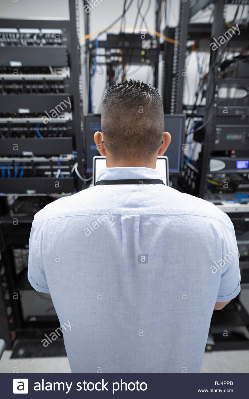 Rear view of a man working on a laptop hi-res stock photography and ...