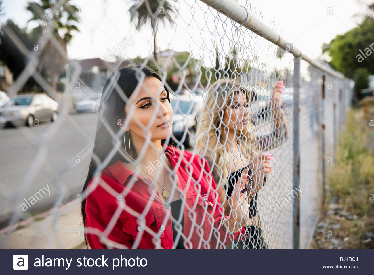 Group of people standing behind fence hi-res stock photography and ...