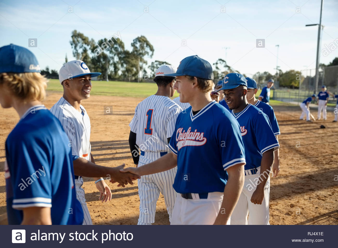 Standing smiling shaking hands uniform hi-res stock photography and ...