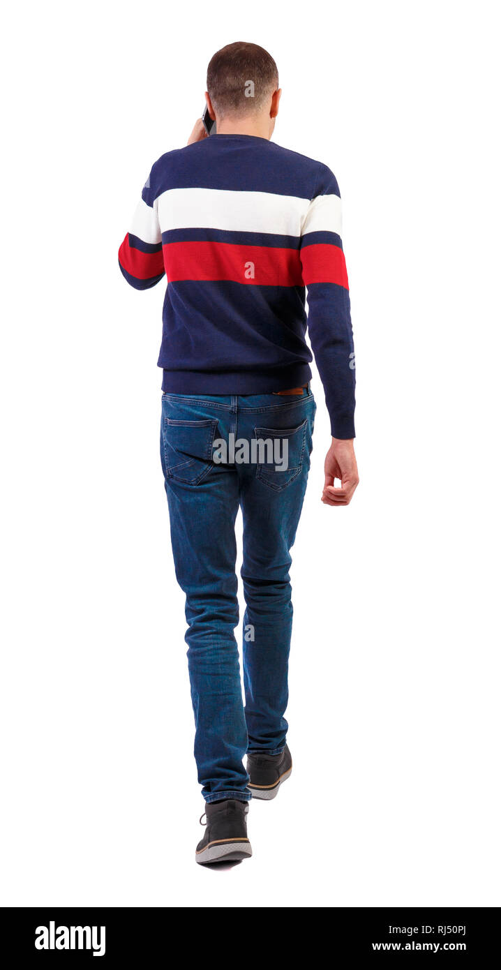 Back view of man walking with a mobile phone. backside view of person ...
