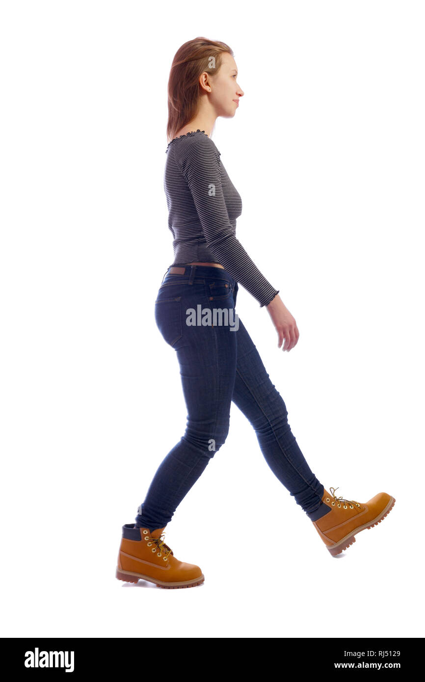 side view of walking woman. beautiful girl in motion. backside view of ...