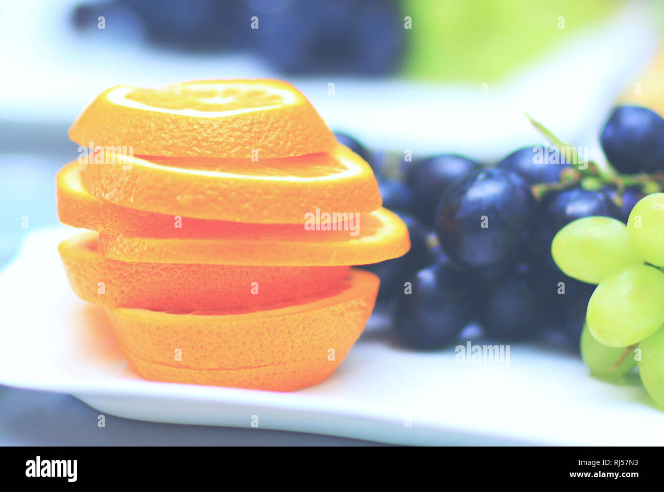 Sliced orange with grapes in the background A variety of delicious food ...