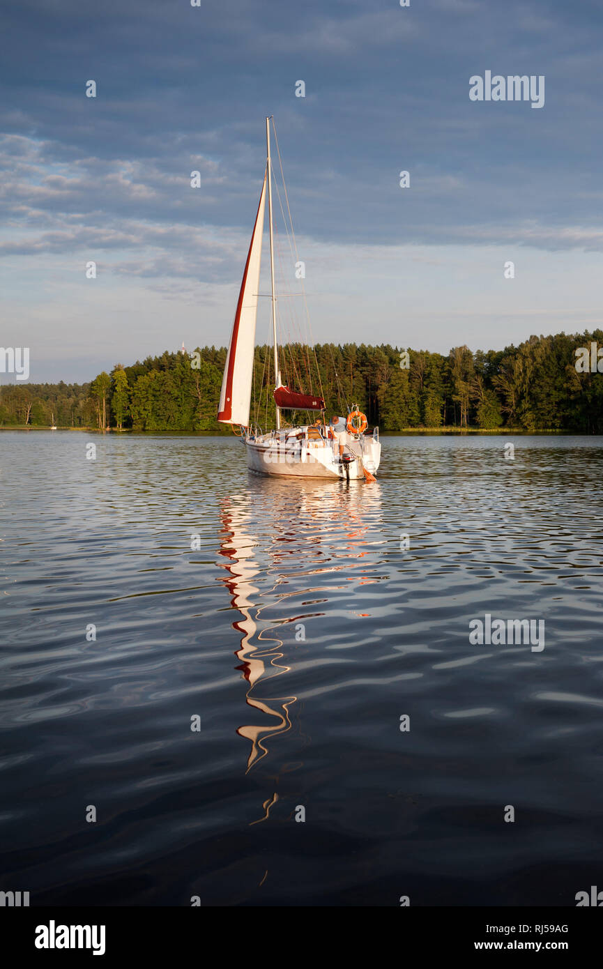 One white boat sailing view at Nidzkie Lake in Ruciane-Nida, Masuria ...