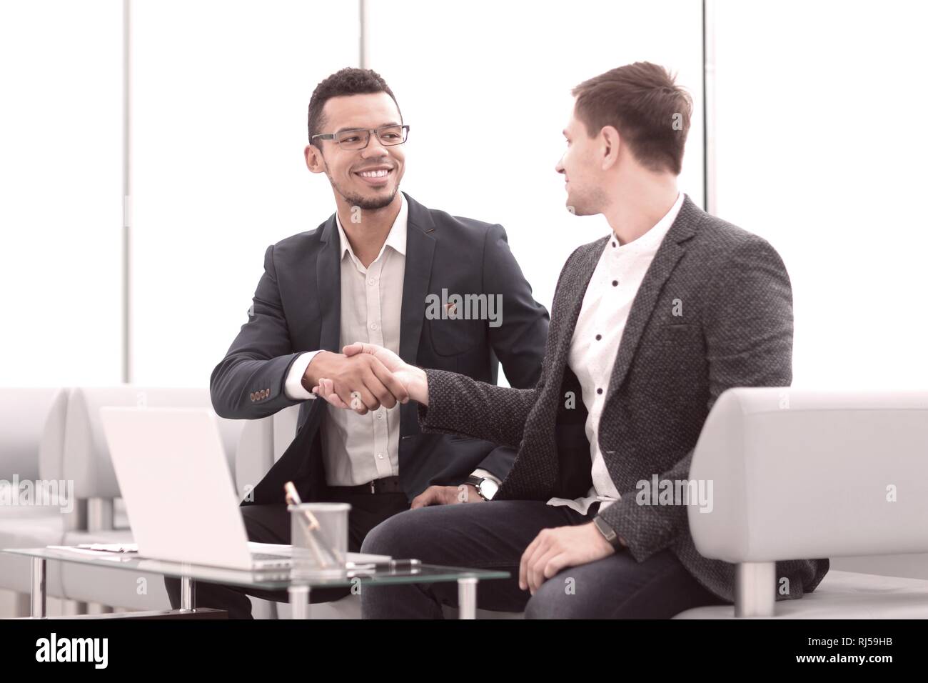 Businessman greeting client in foyer hi-res stock photography and ...