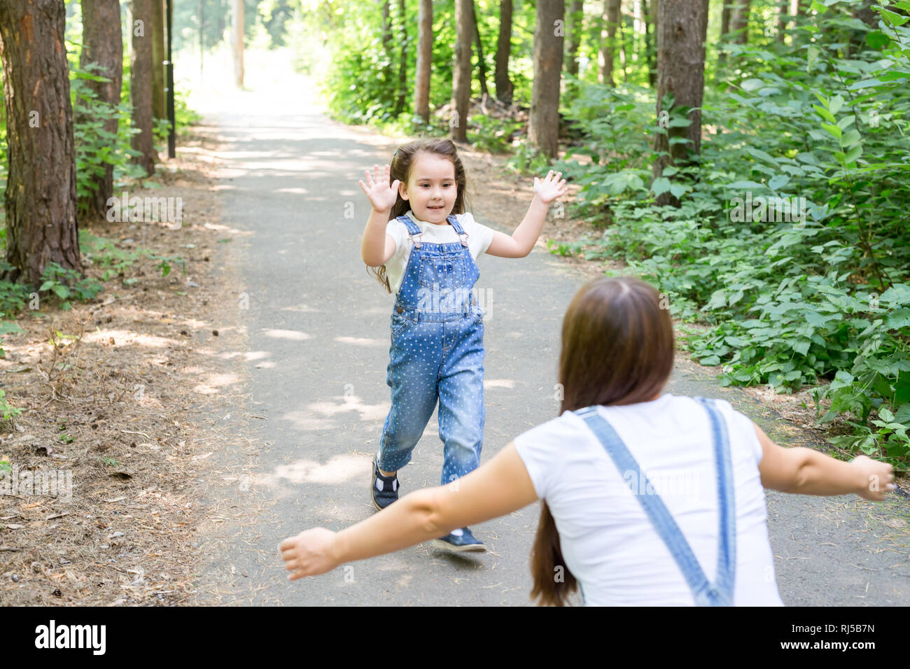 Nature, family, people concept - Adorable little kid girl and young ...