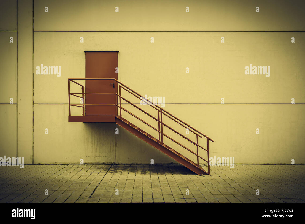 Red metal staircase on the outside, detail of a red painted ladder ...