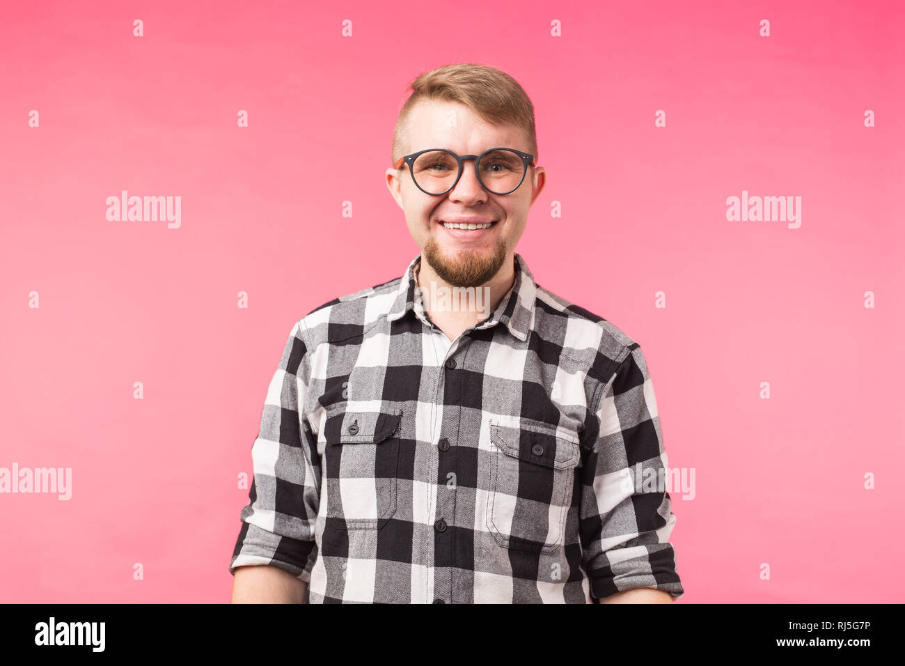 Student, geek and people concept - a young man in glasses smiling over ...