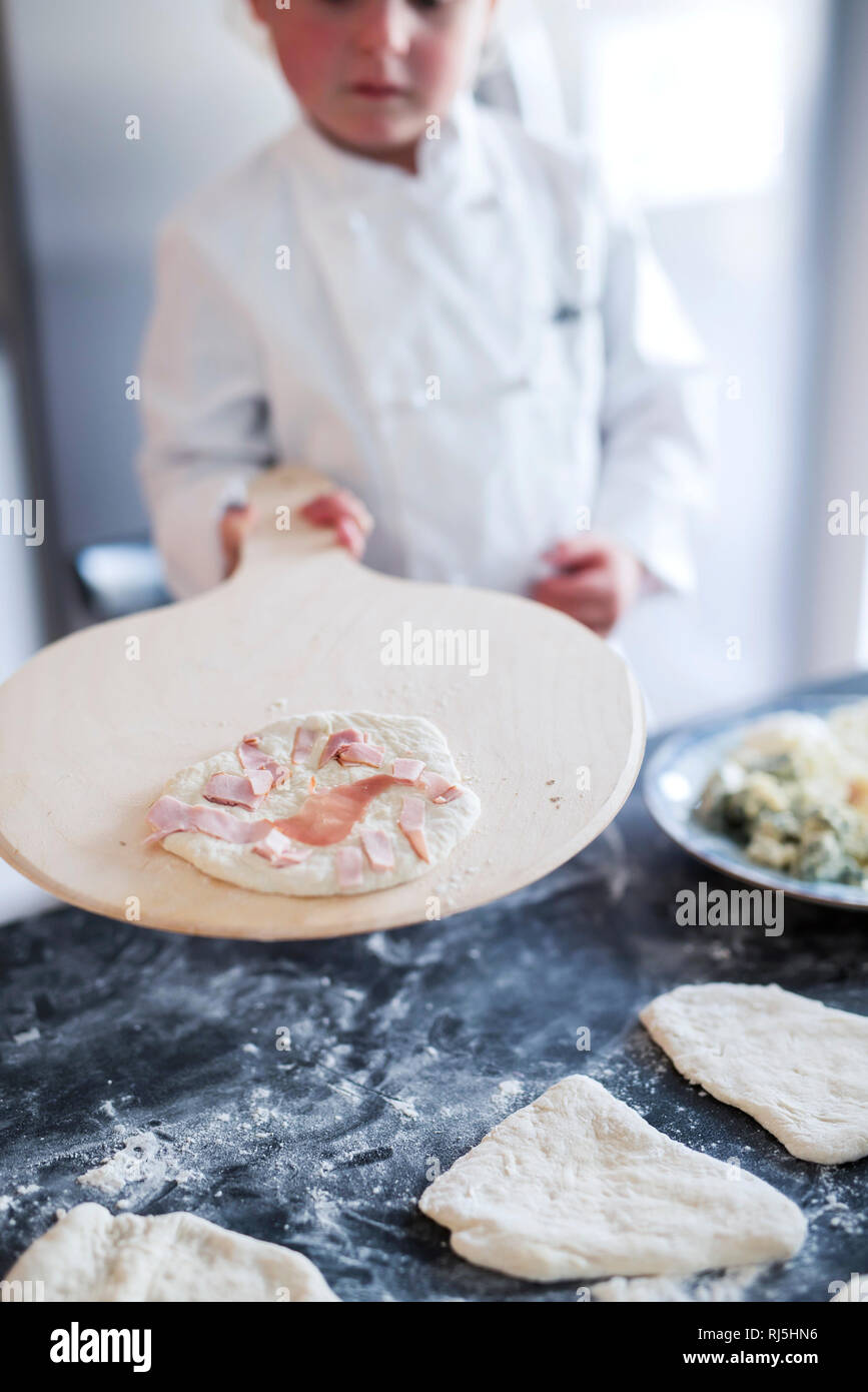 Boy making pizza in kitchen Stock Photo - Alamy