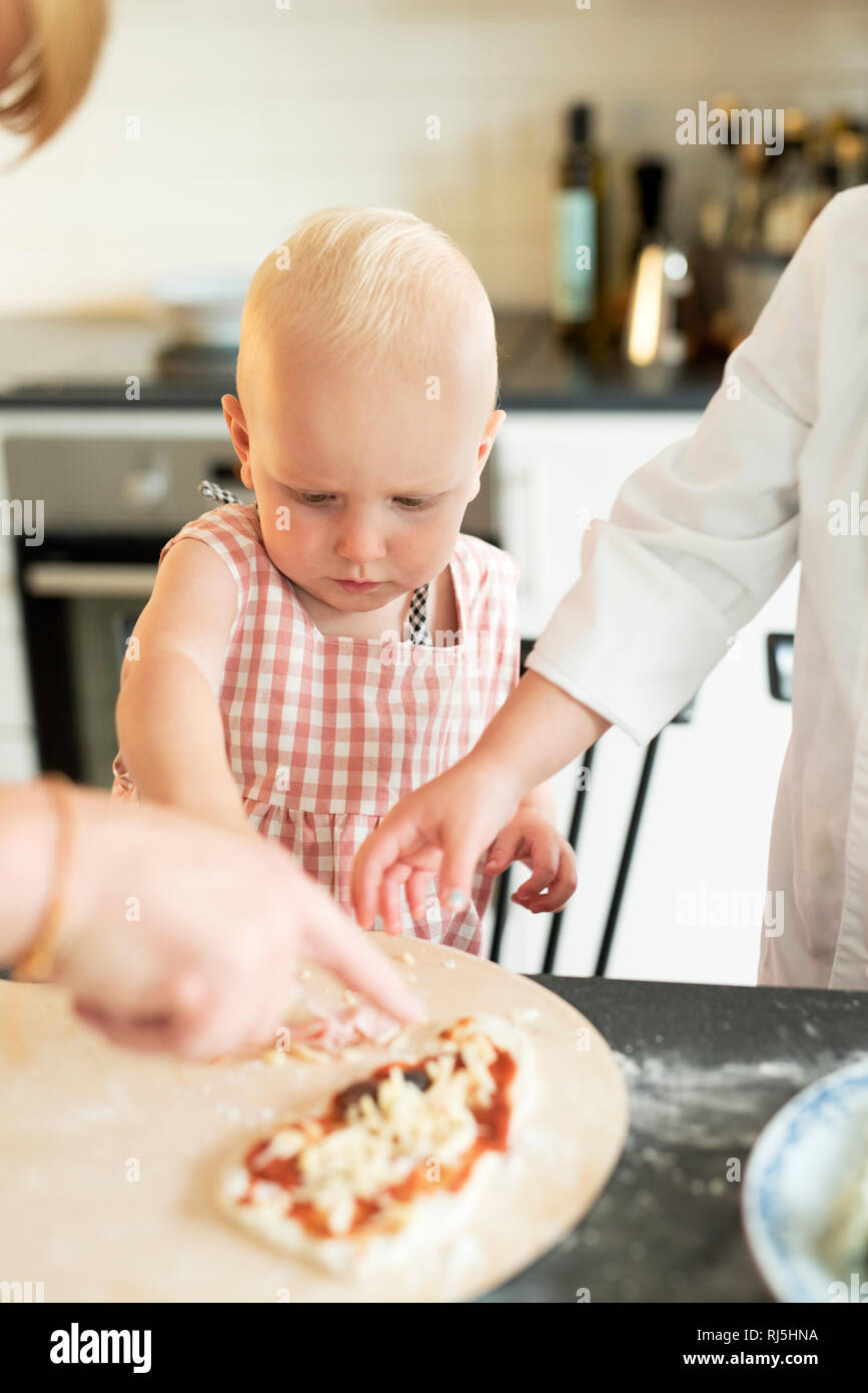 Father making pizza with sons Stock Photo - Alamy