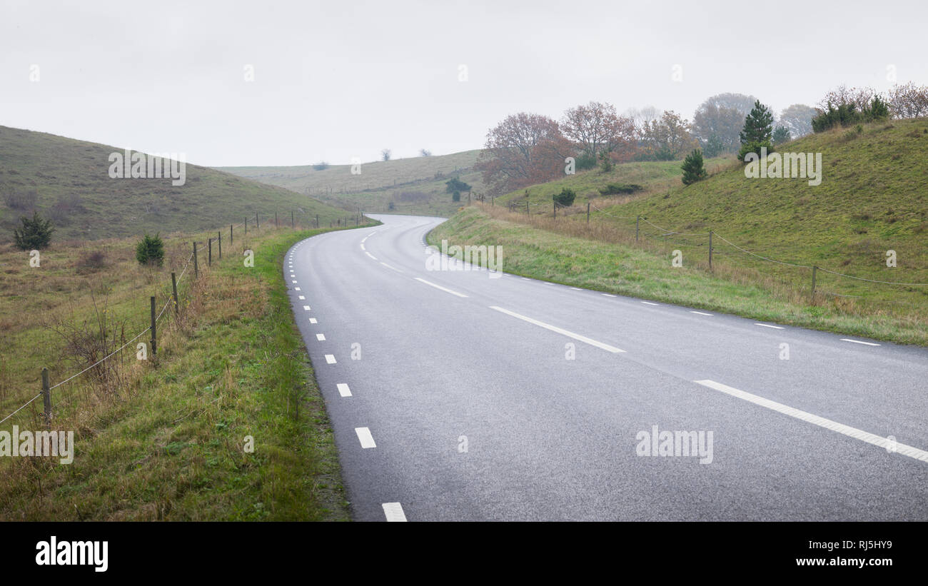 Empty road with hills in background Stock Photo - Alamy