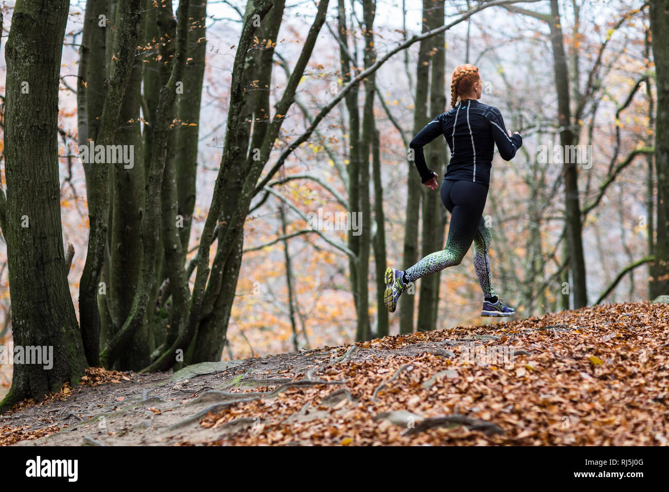 Young woman running in forest hi-res stock photography and images - Alamy