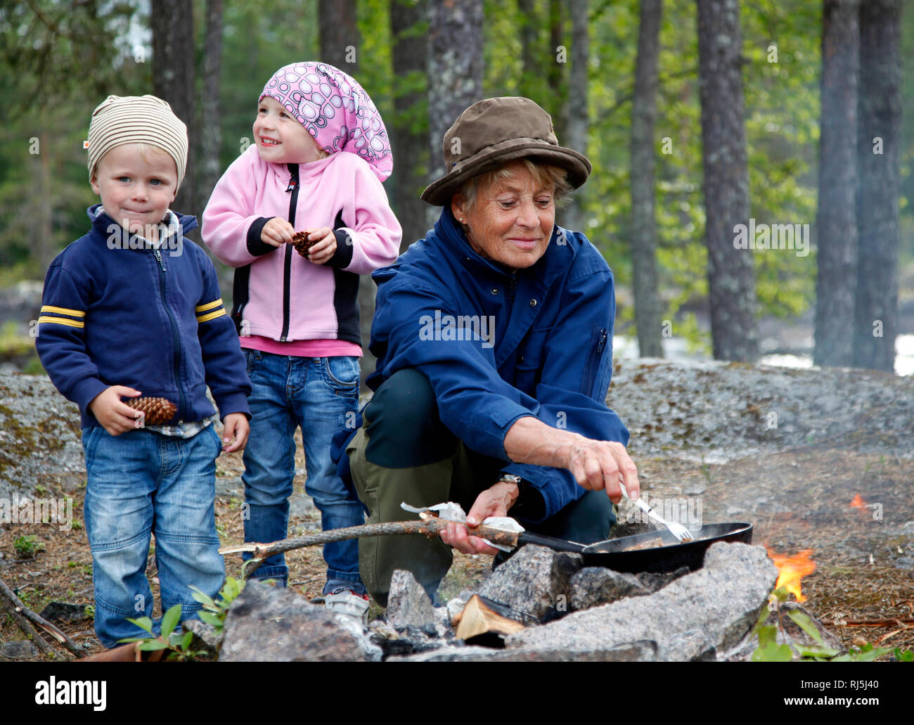 Family cooking over fire Stock Photo - Alamy