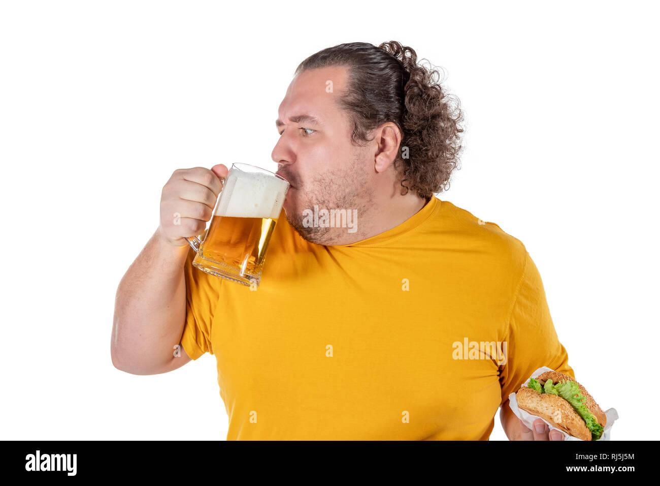 Funny fat man eating burger and drinking alcohol beverage Stock Photo ...