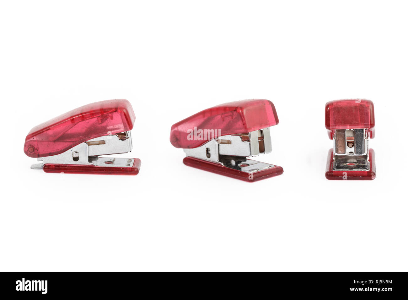 Three pink staplers isolated on white background Stock Photo - Alamy