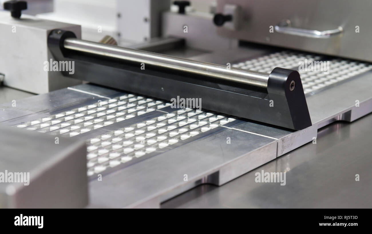 Pharmaceutical medicine tablet pill production line Stock Photo - Alamy