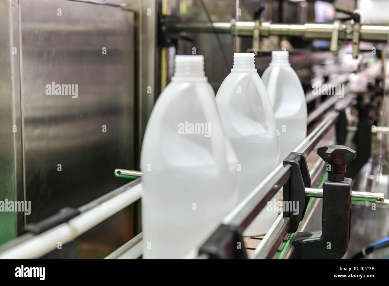 White plastic Bottles transfer on Automated conveyor systems industrial ...