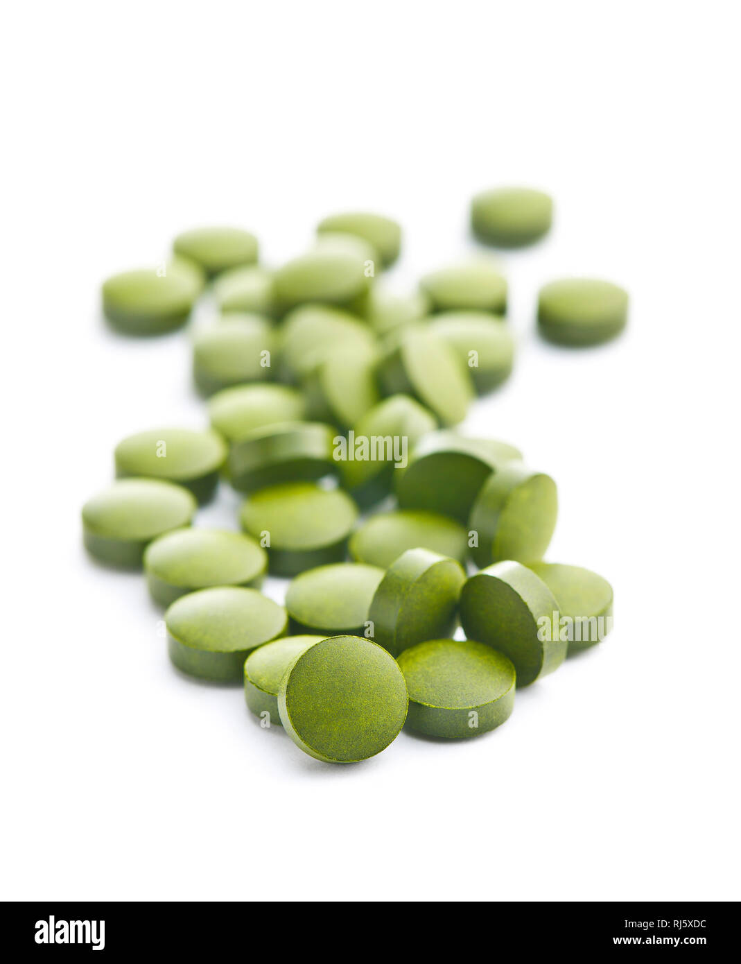 Green chlorella pills or green barley pills isolated on white ...