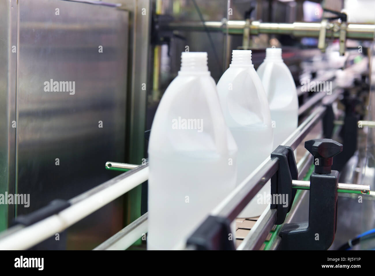 White plastic Bottles transfer on Automated conveyor systems industrial ...