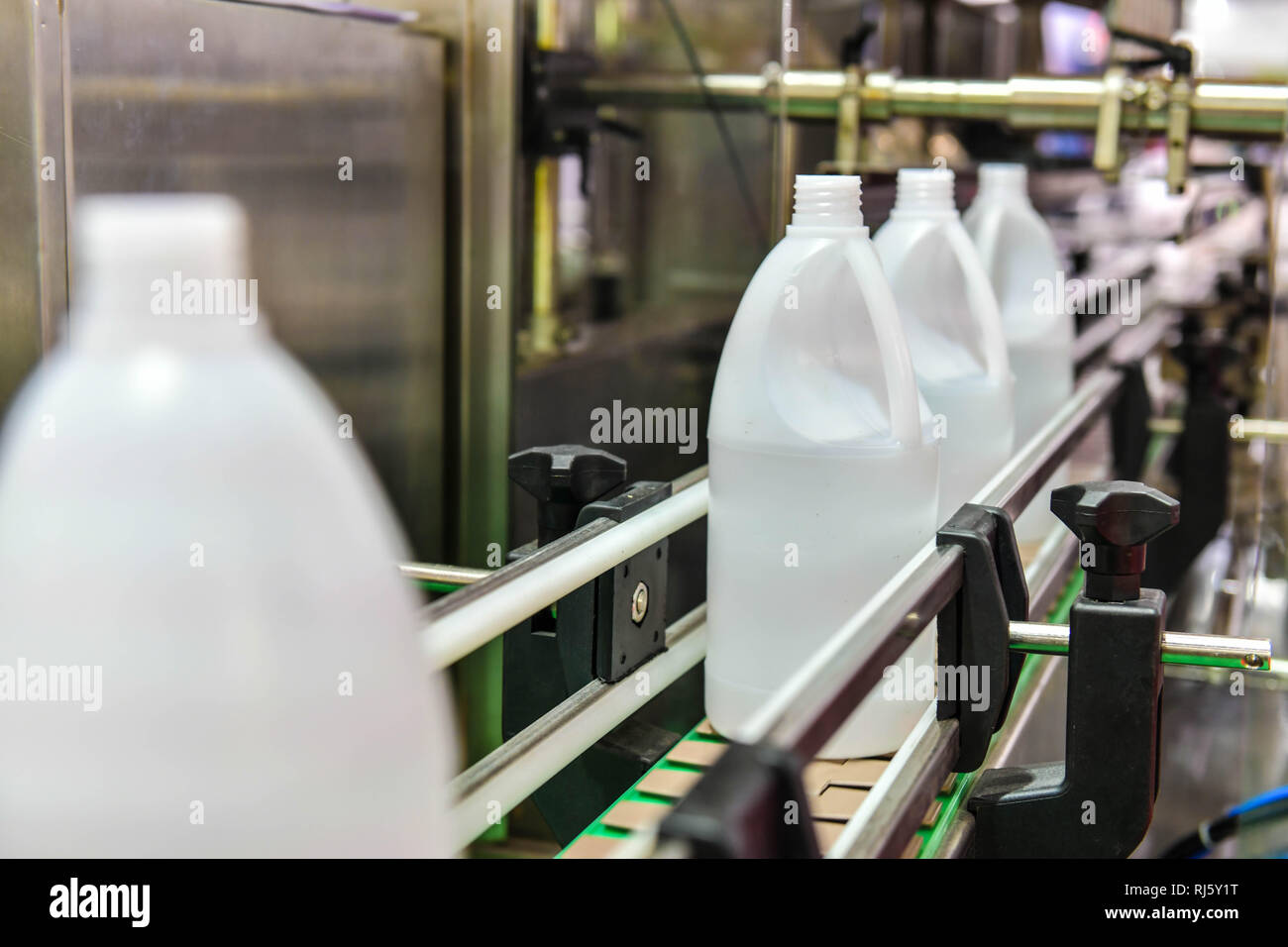 White plastic Bottles transfer on Automated conveyor systems industrial ...