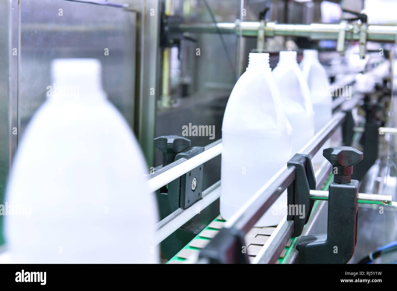 White plastic Bottles transfer on Automated conveyor systems industrial ...