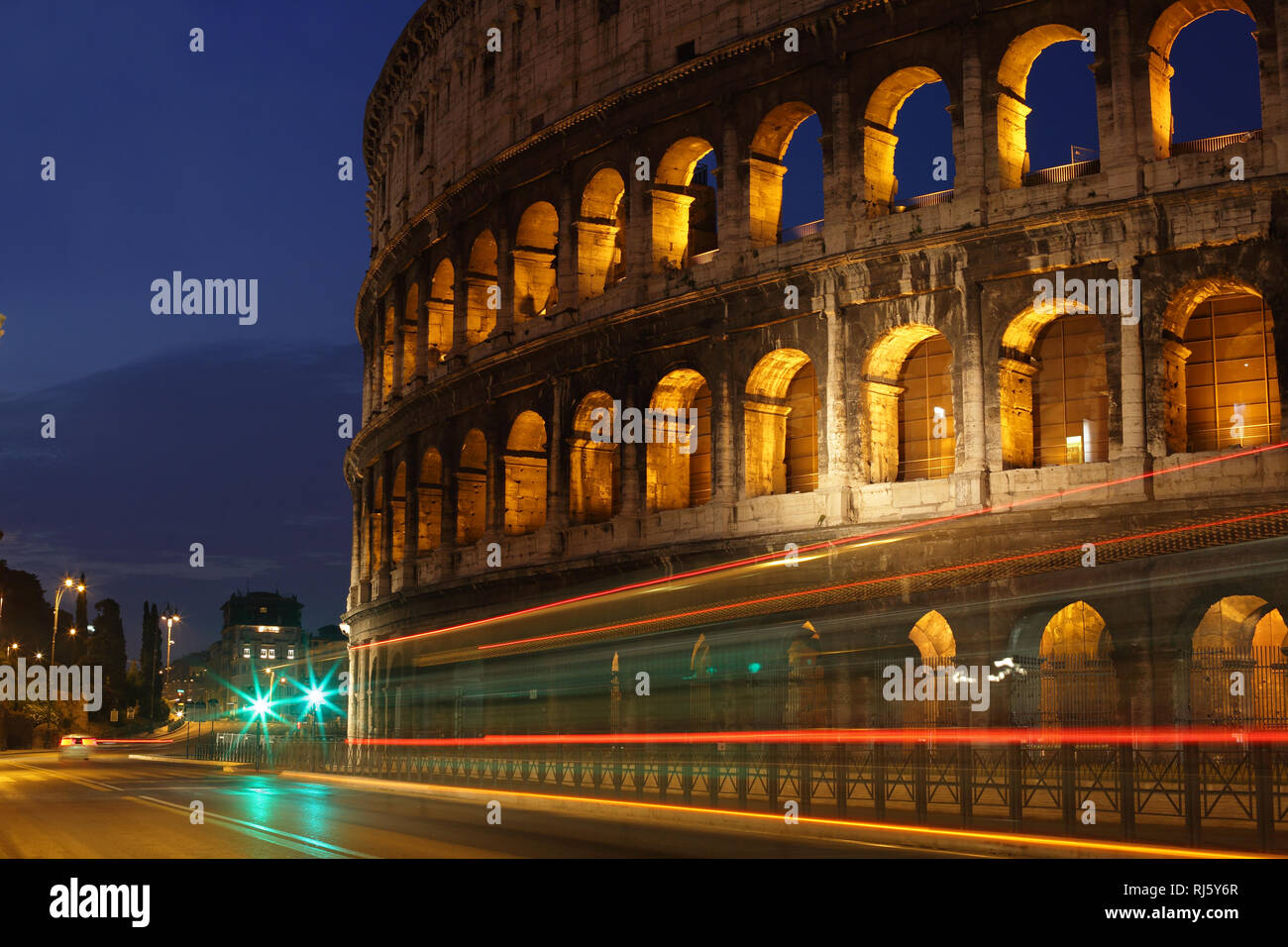 Colosseum at night with colorful blurred traffic lights. Rome, Italy ...