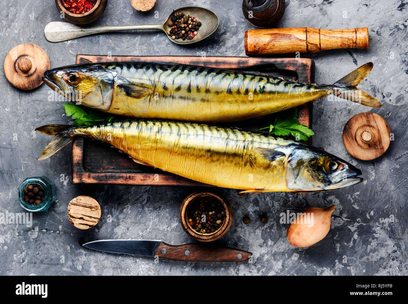 Appetizing smoked fish on kitchen board.Smoked mackerel.Mediterranean ...