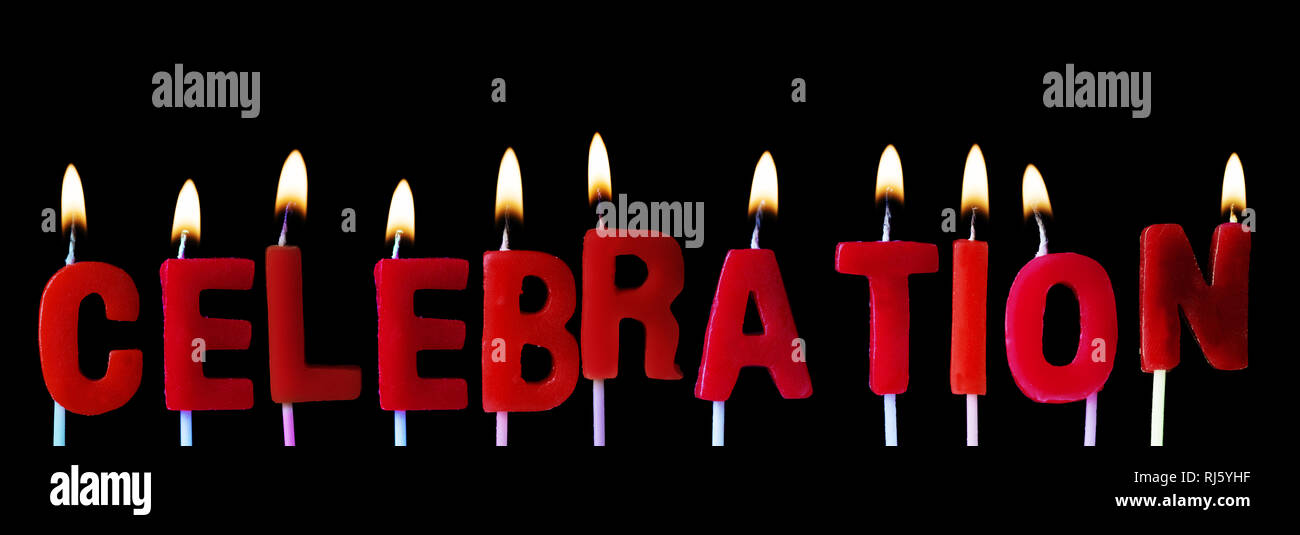 Celebration spellt out in red birthday candles against a black ...
