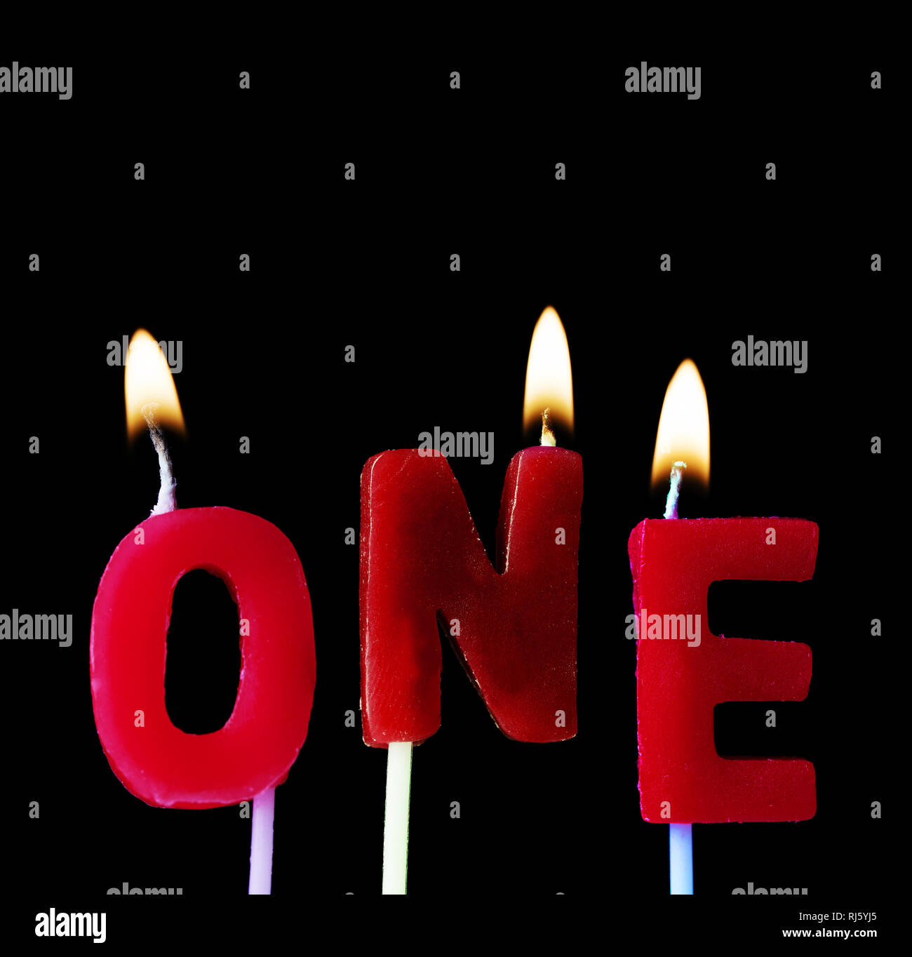 One spellt out in red birthday candles against a black background Stock ...