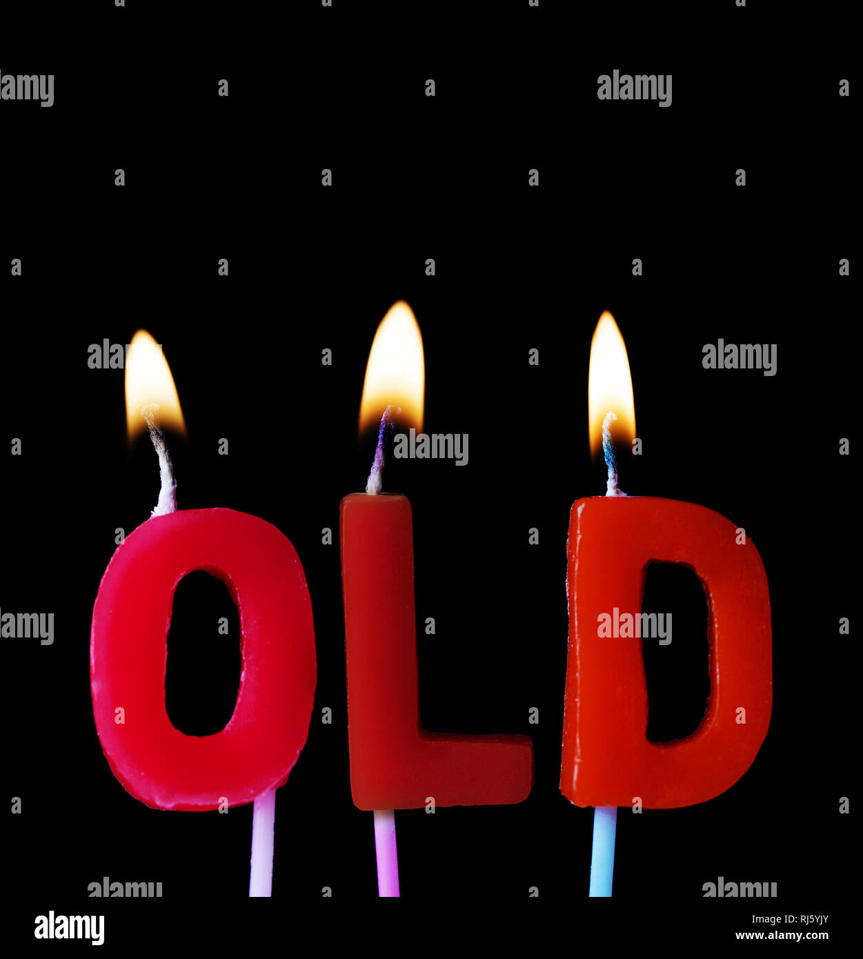 Old spellt out in red birthday candles against a black background Stock ...