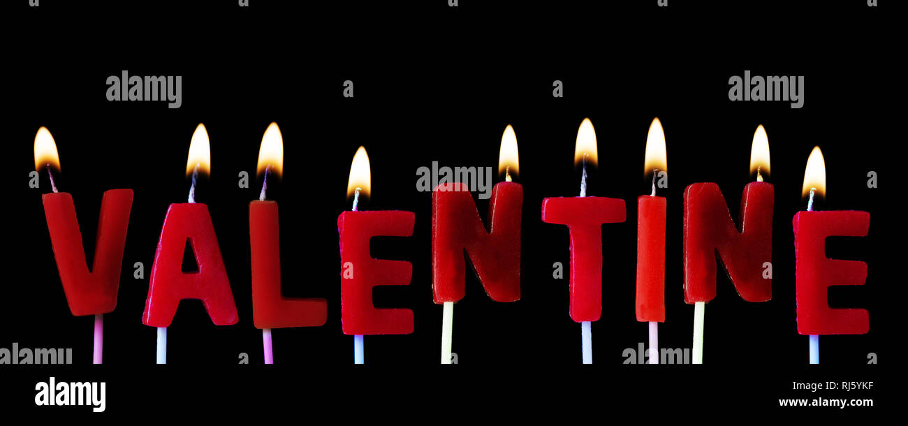 Valentine spellt out in red candles against a black background Stock ...
