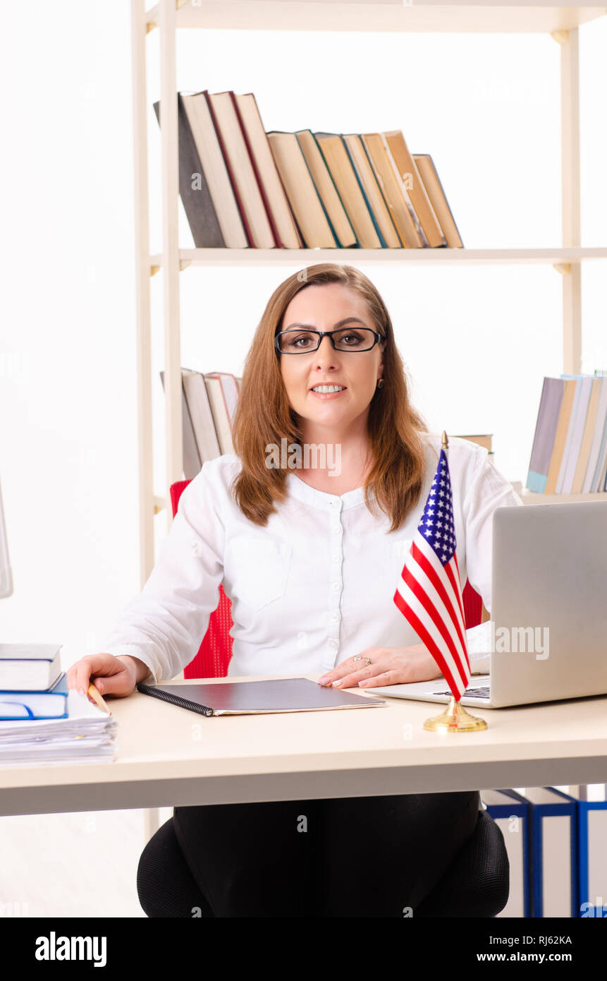 Female english teacher in the classroom Stock Photo - Alamy