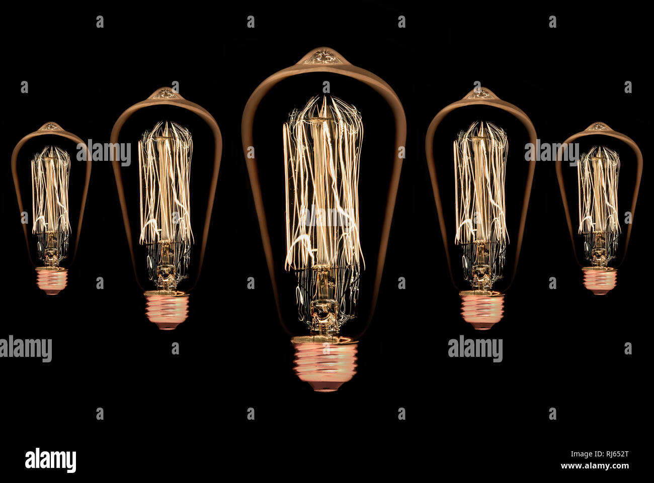 Incandescent light bulb on black background Stock Photo - Alamy