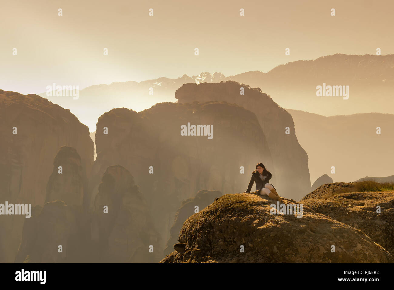Woman sitting on the rocks hi-res stock photography and images - Alamy