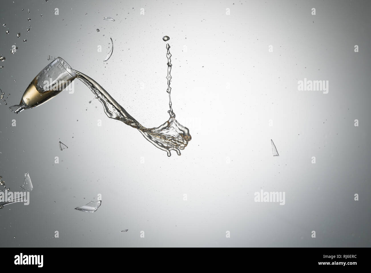 Flying wine glasses with poured alcohol on a gradient background. A ...