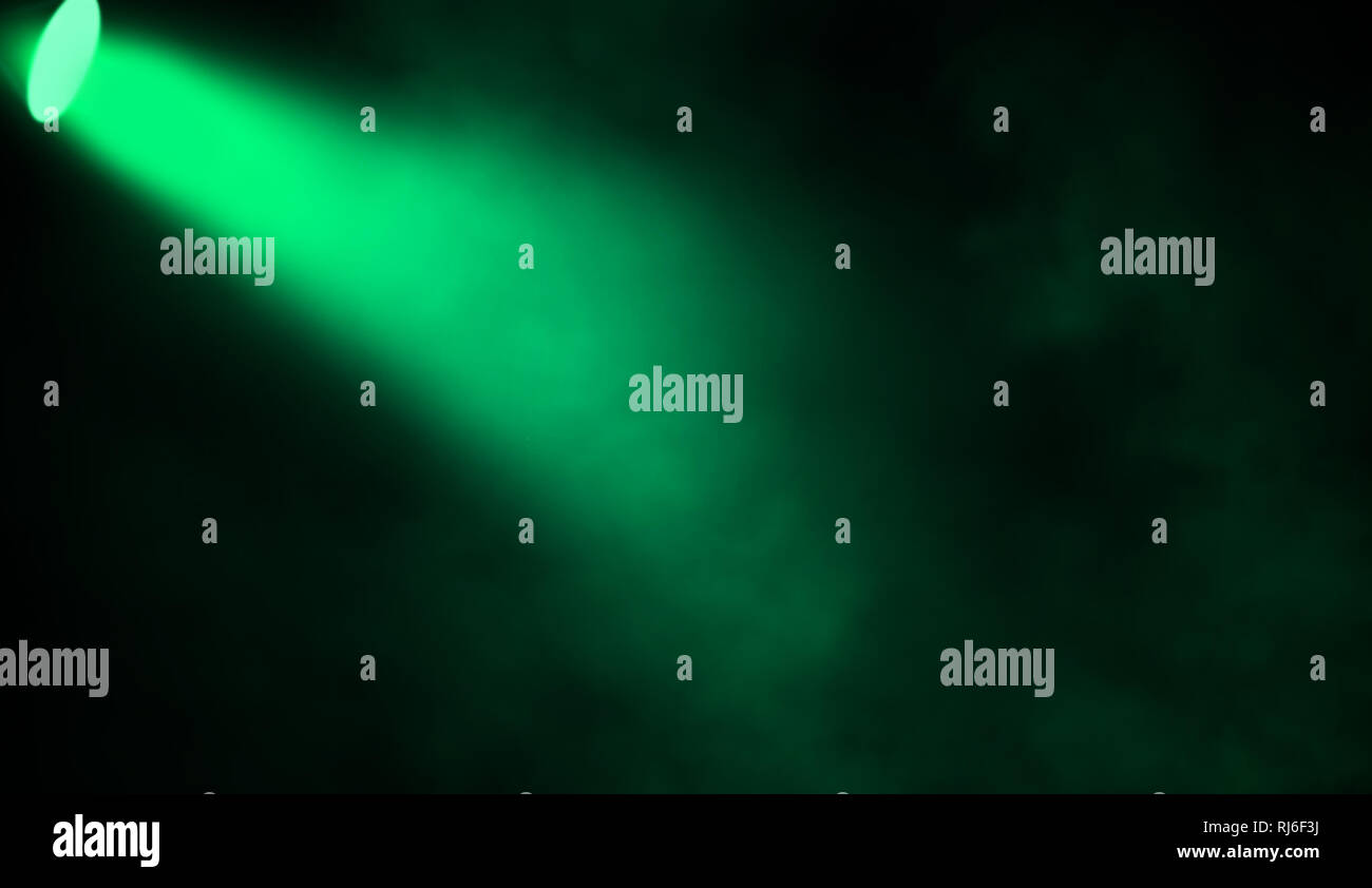 Green projector. Spotlight stage with smoke on black background Stock ...