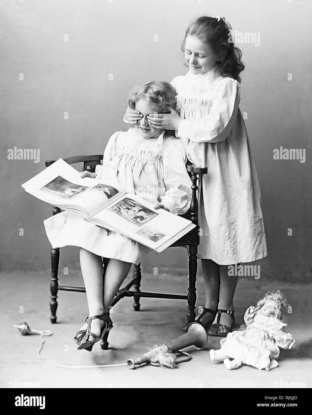 Children palying peek a boo Stock Photo - Alamy