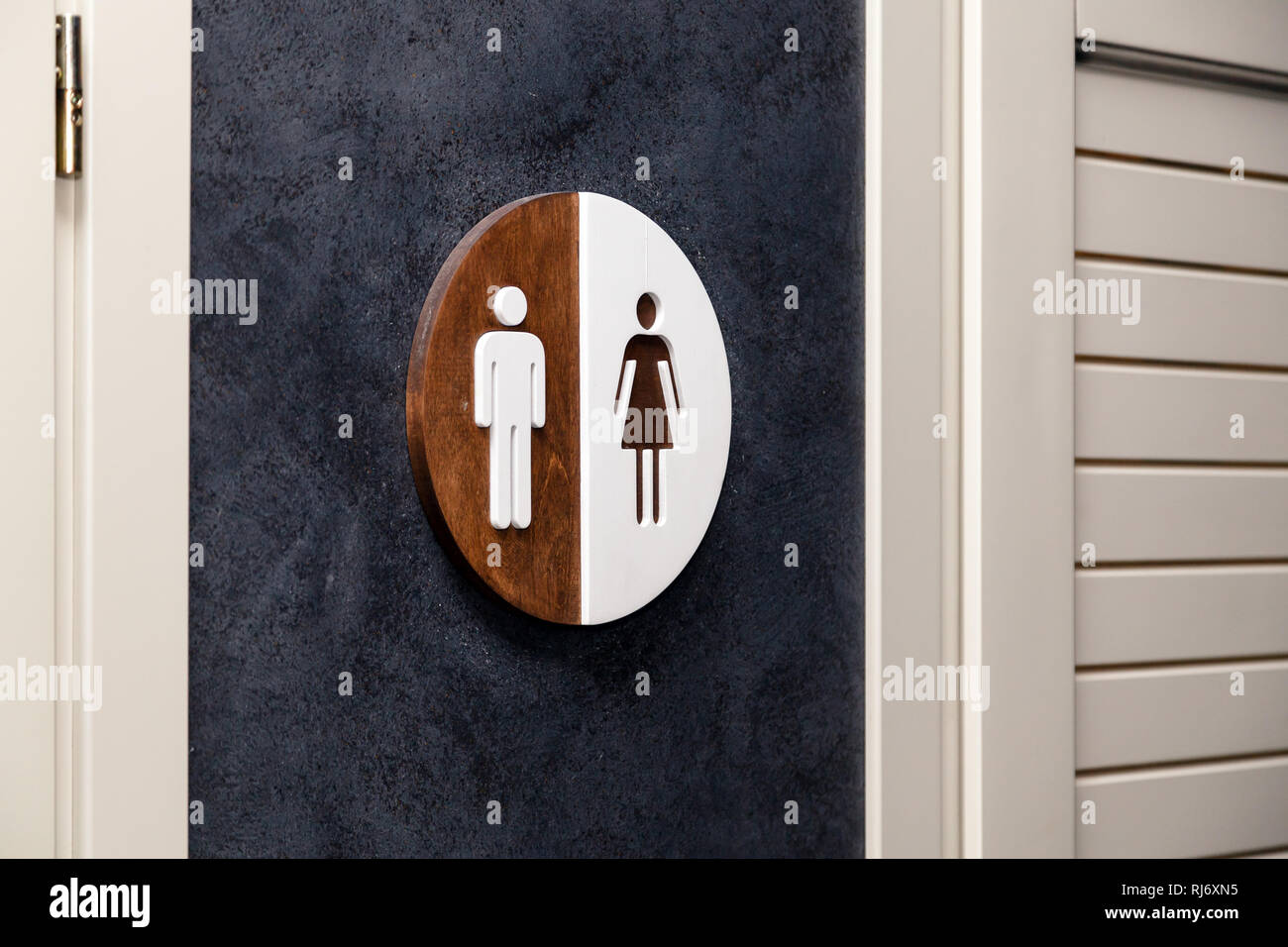 Toilet, wc icon, round wooden white and brown sign on restroom door in ...