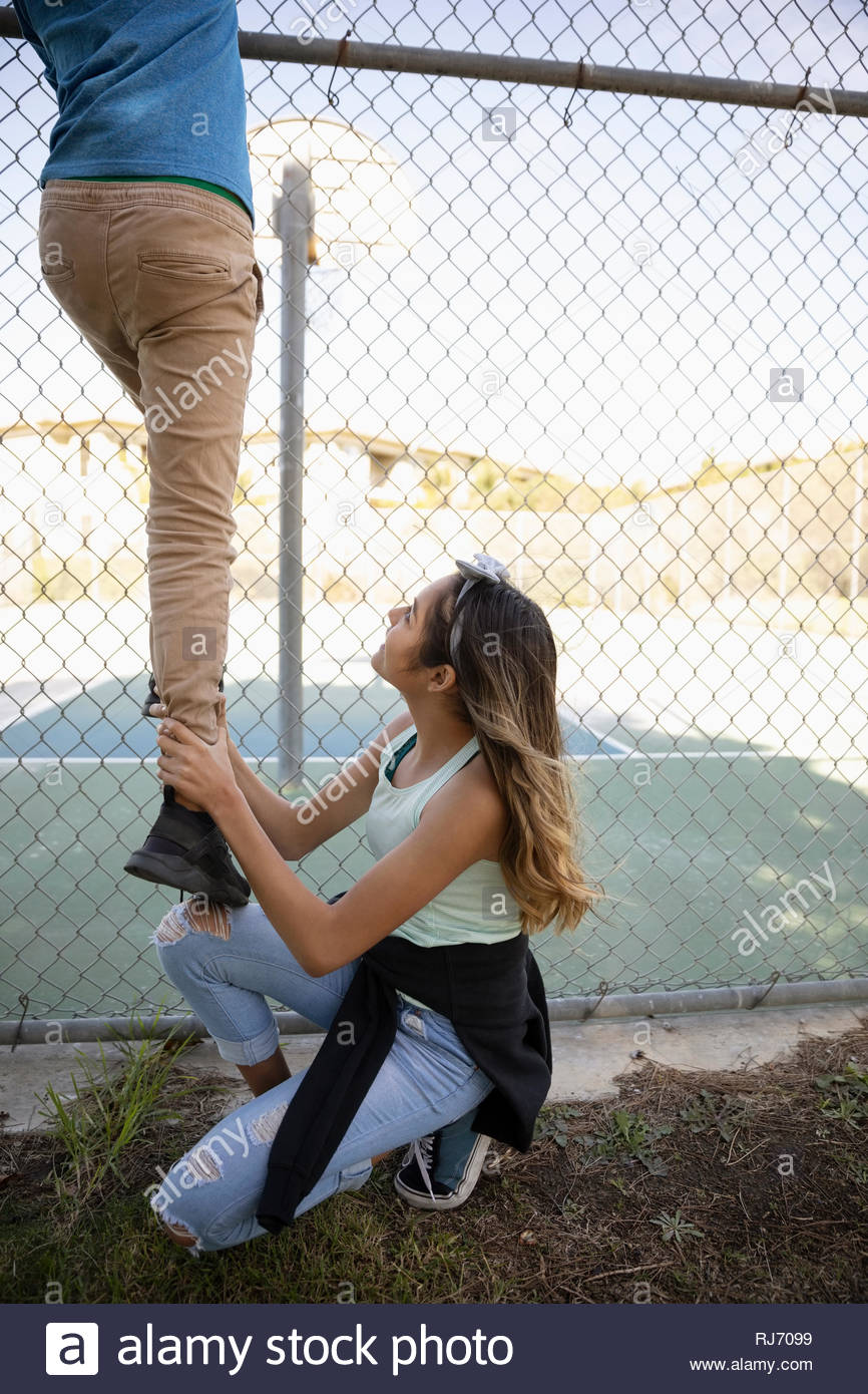 Girl climbing over fence hi-res stock photography and images - Alamy