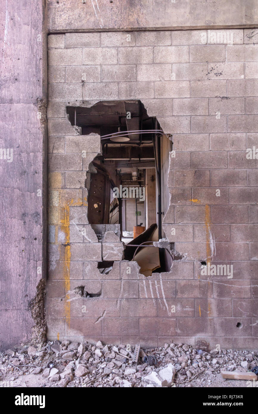 An irregular shape hole in a wall in an abandoned ruined building, see ...