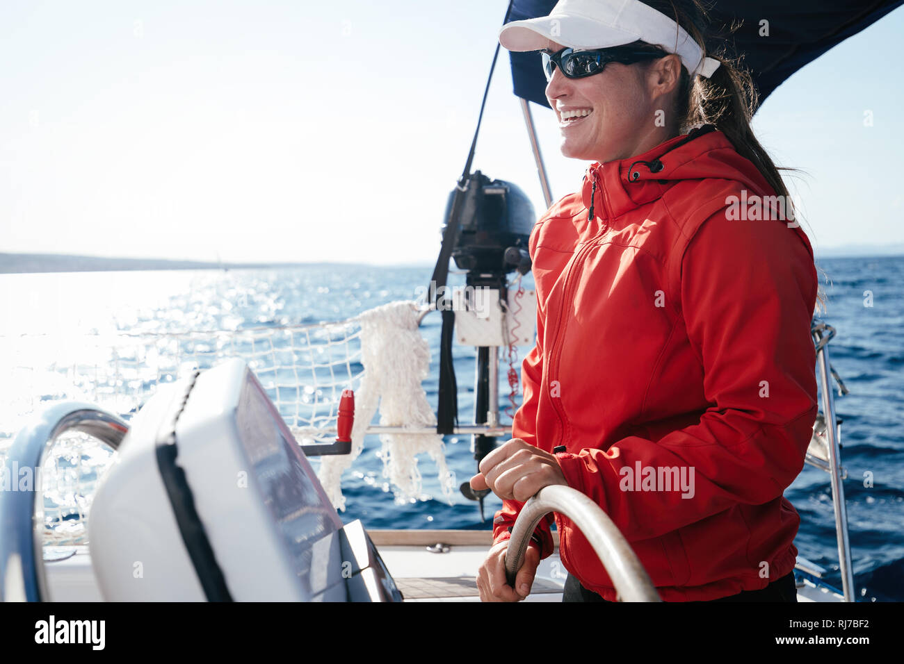 Attractive strong woman sailing with her boat Stock Photo - Alamy