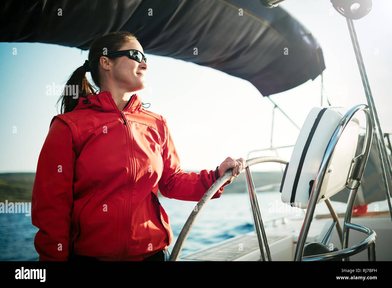 Attractive strong woman sailing with her boat Stock Photo - Alamy