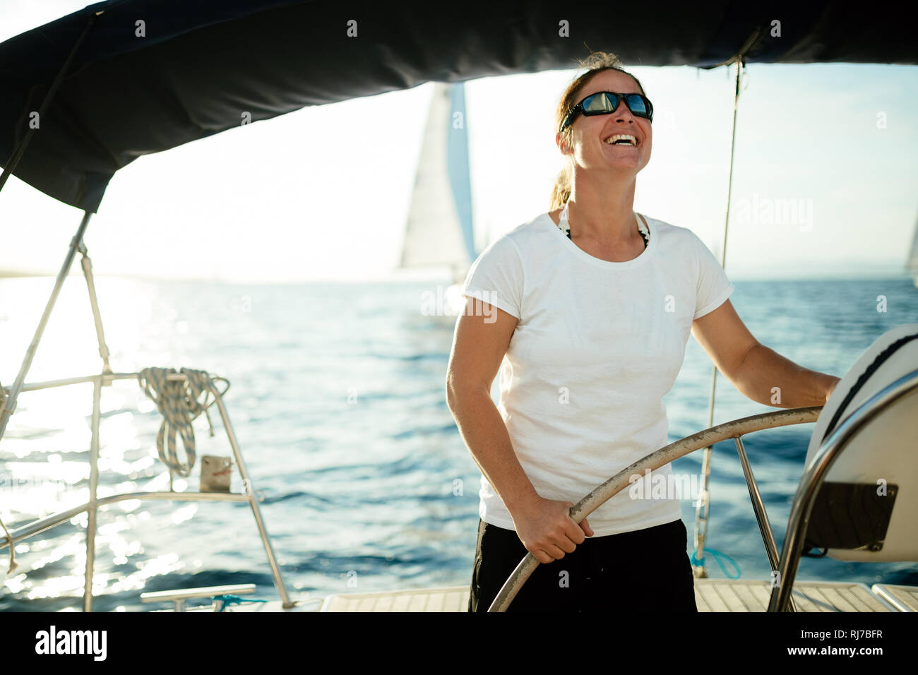 Attractive strong woman sailing with her boat Stock Photo - Alamy