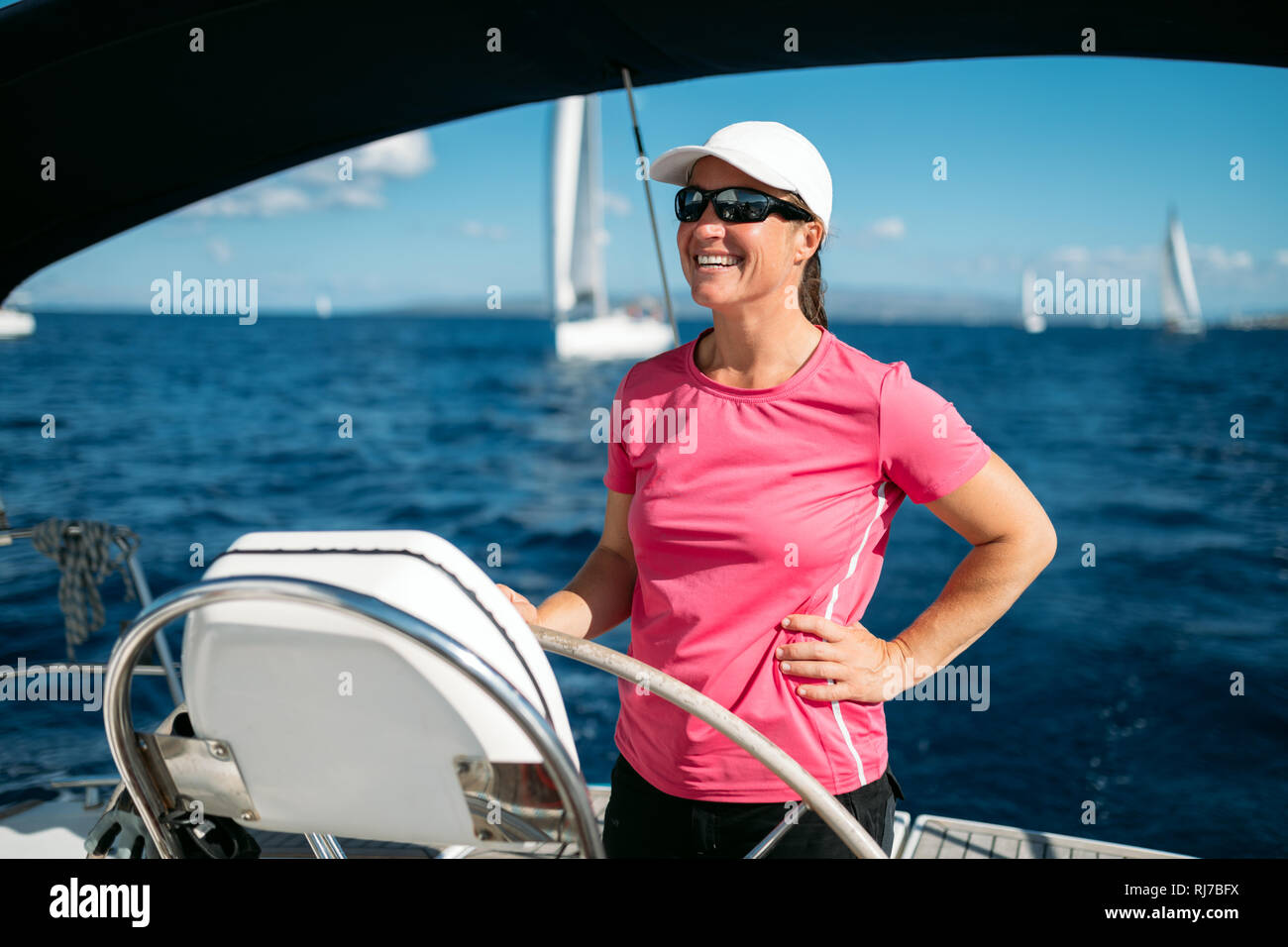 Happy strong woman sailing with her boat Stock Photo - Alamy