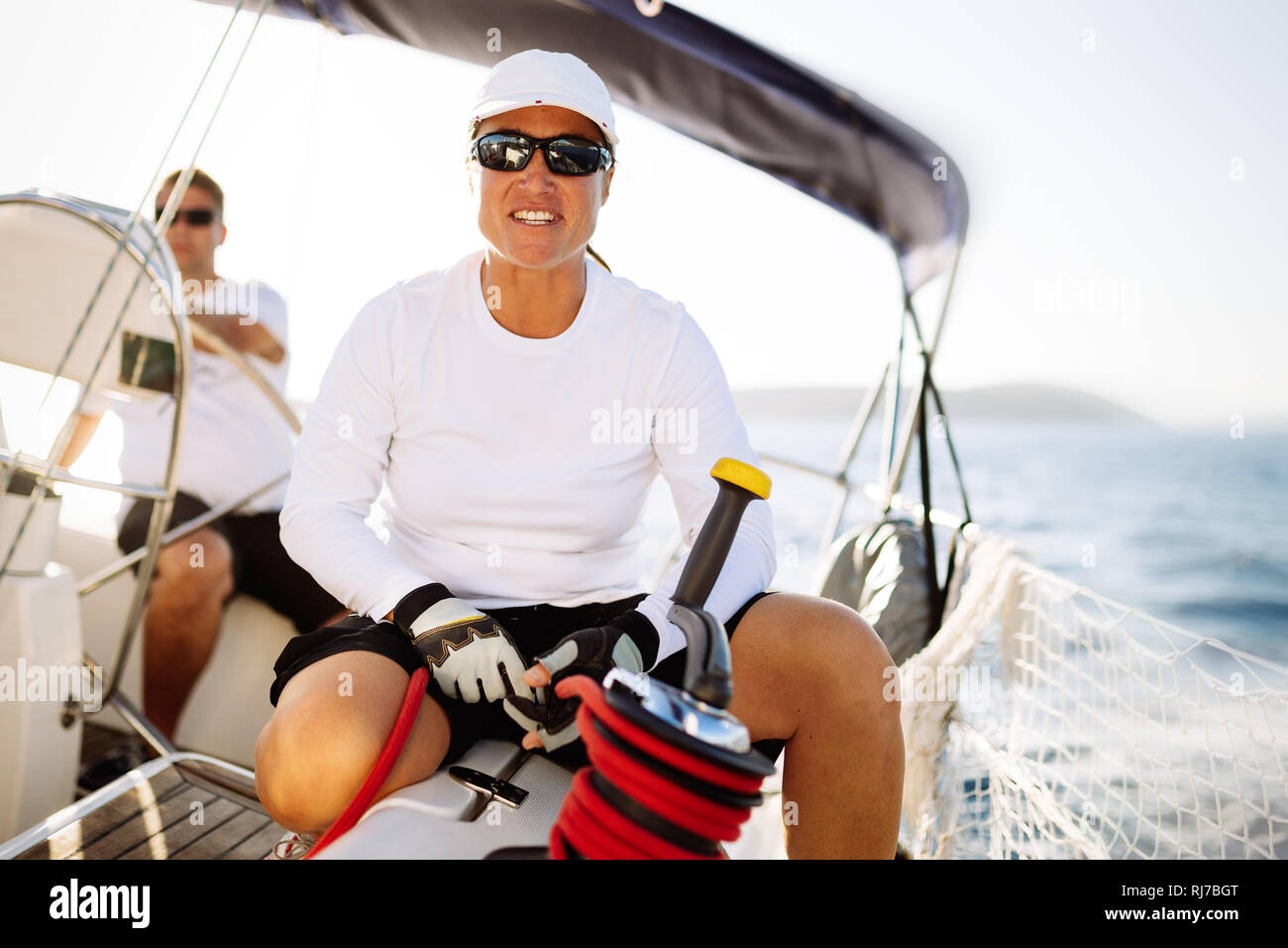 Attractive strong woman sailing with her boat Stock Photo - Alamy