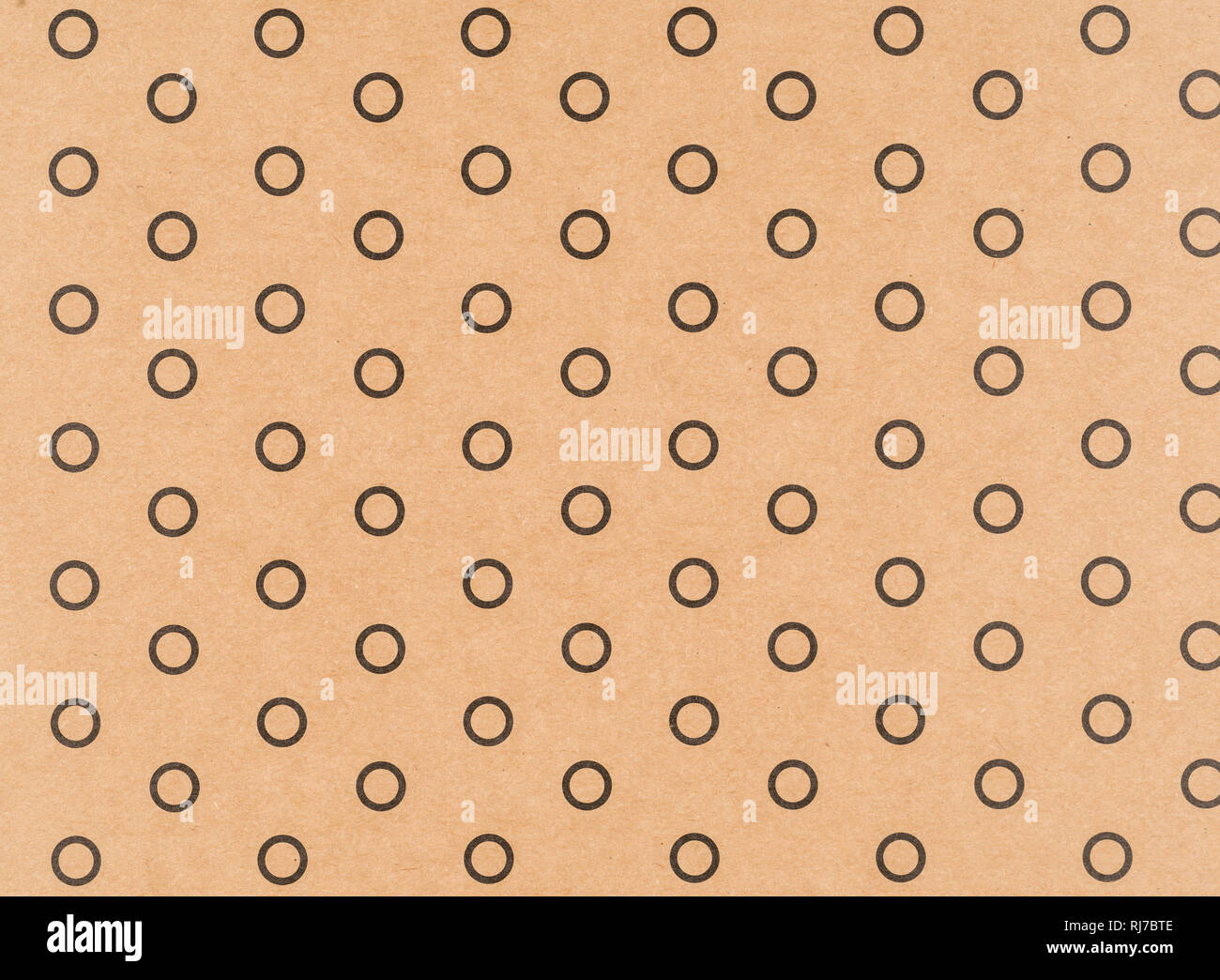 Brown craft paper with a black circle pattern Stock Photo - Alamy